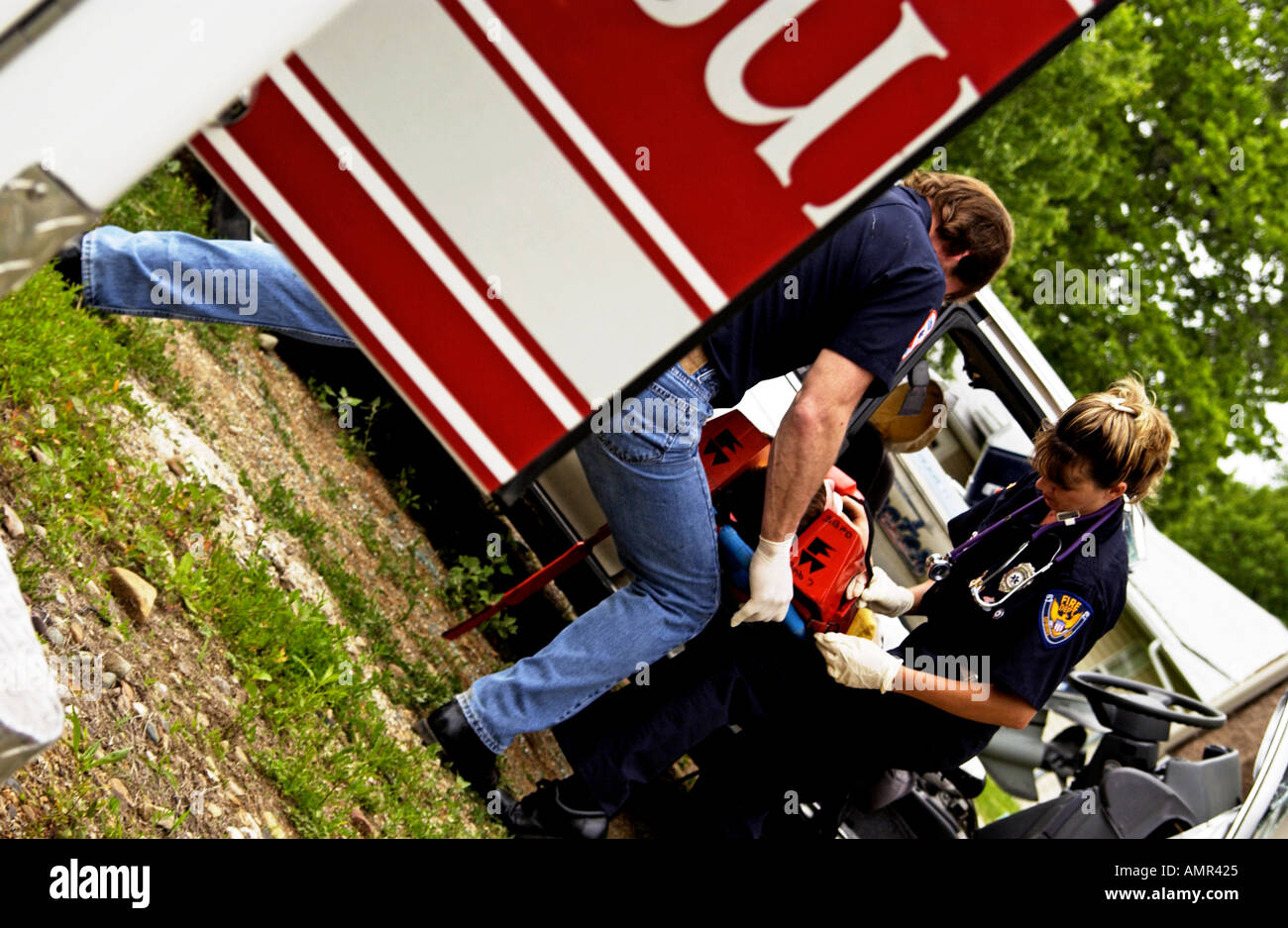 EMTs helping victim from car crash Stock Photo - Alamy