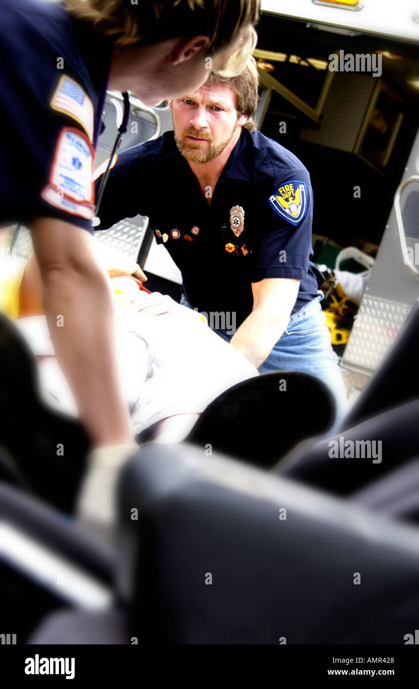EMTs helping victim from car crash Stock Photo - Alamy