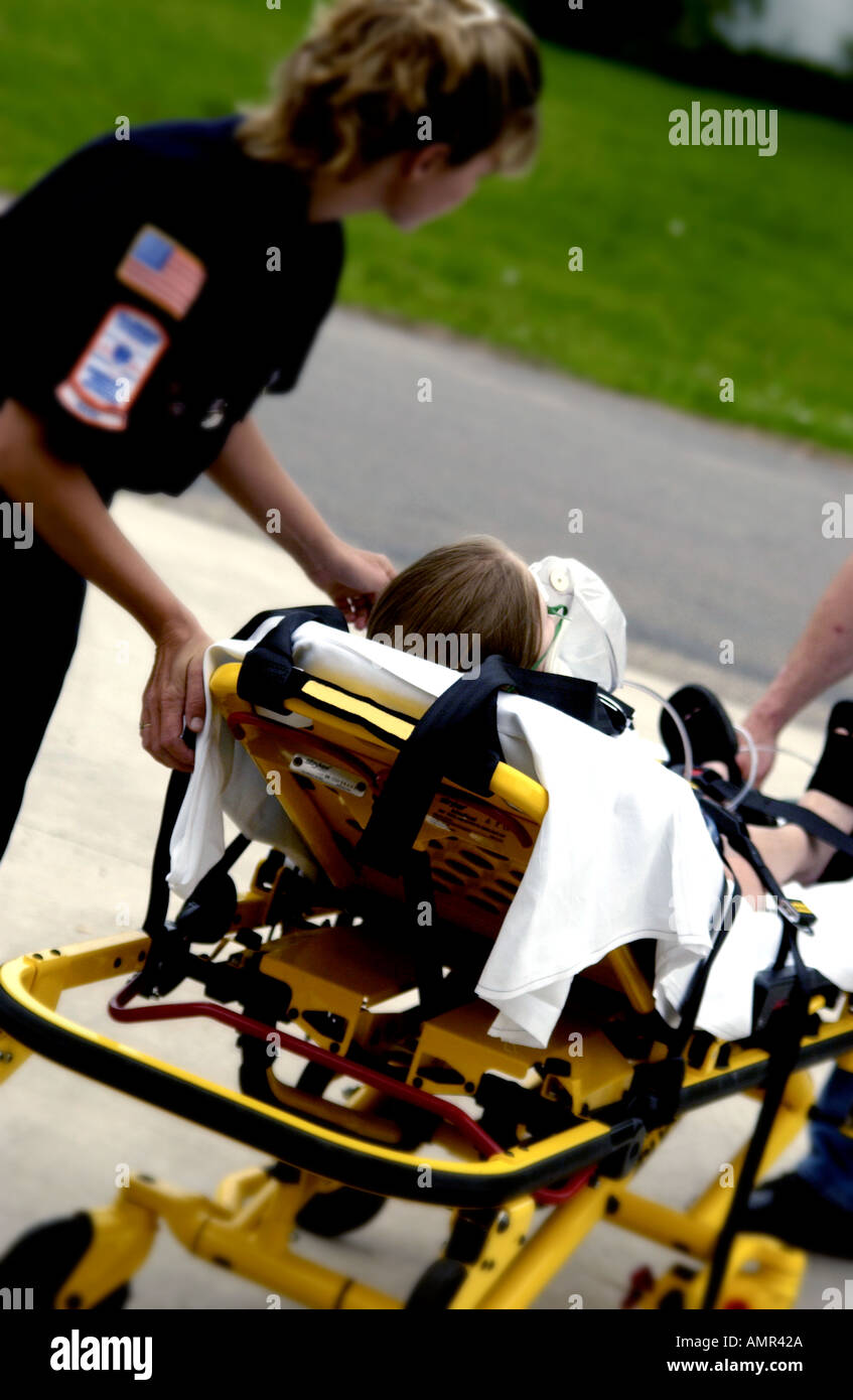 EMTs loading patient into ambulance Stock Photo - Alamy