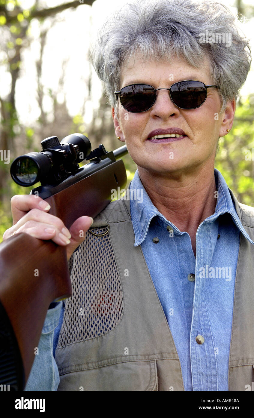 Woman carrying rifle Stock Photo - Alamy