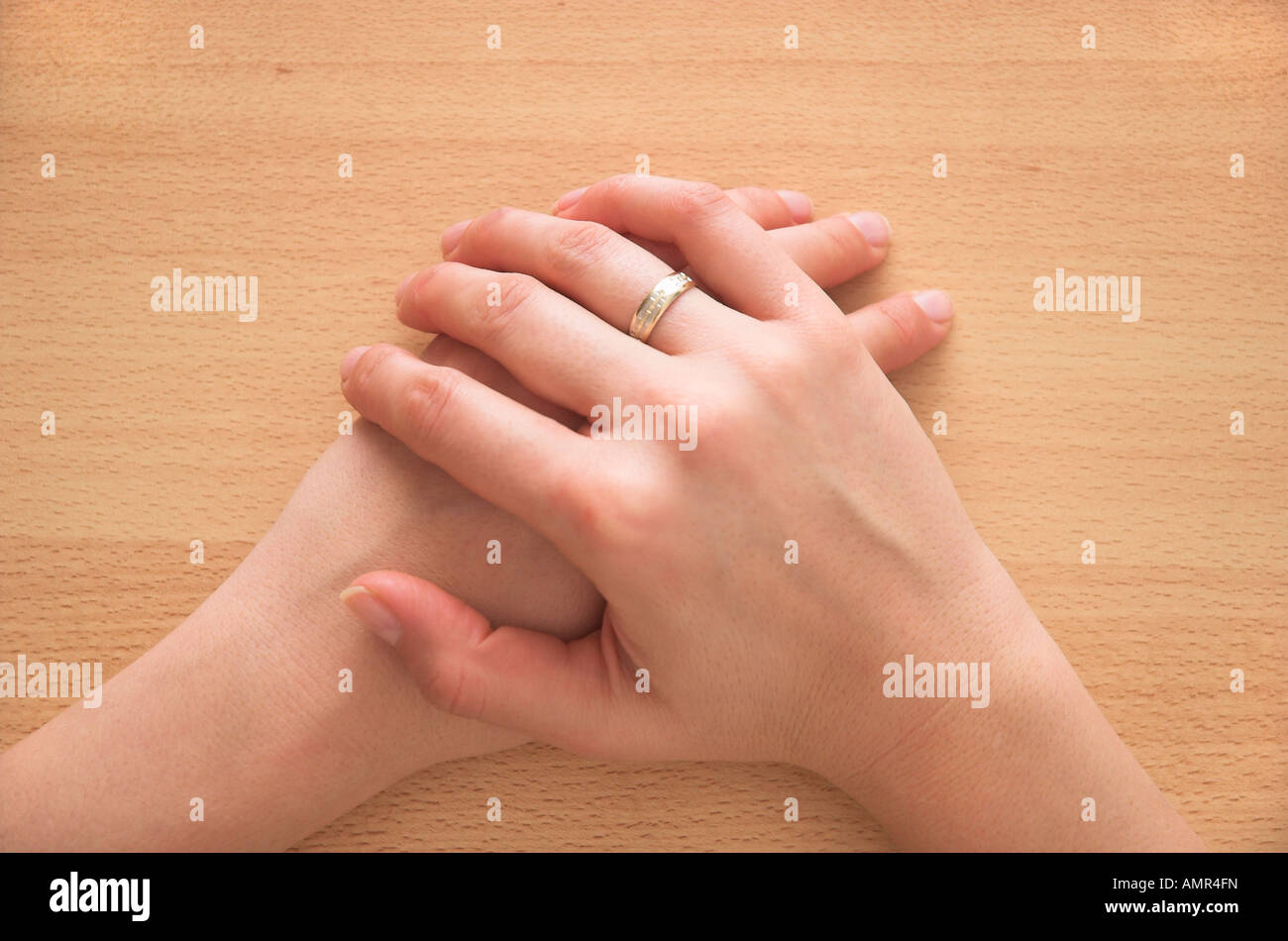 Womans hands resting on table Stock Photo - Alamy