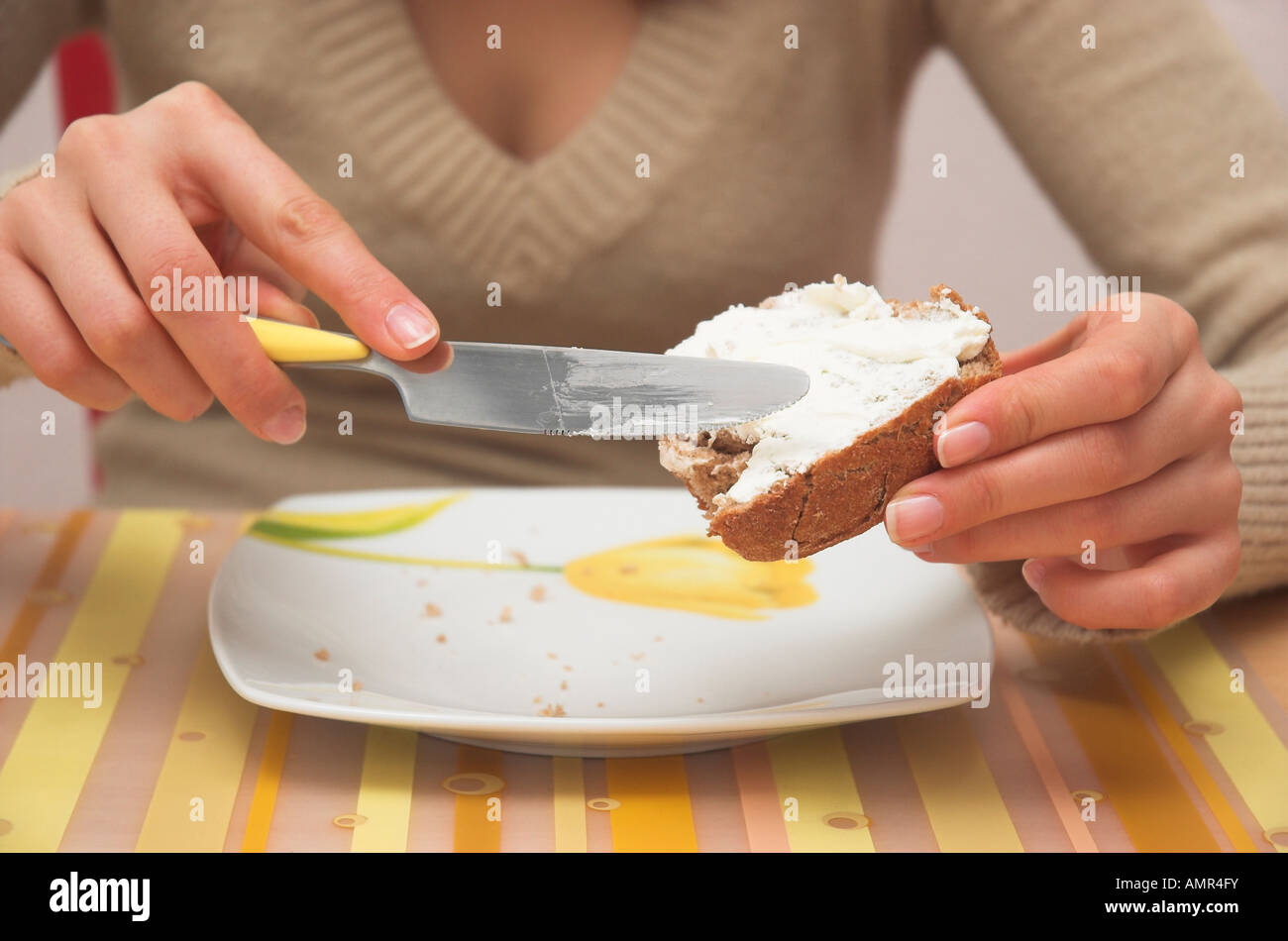 Woman eating bread Stock Photo - Alamy