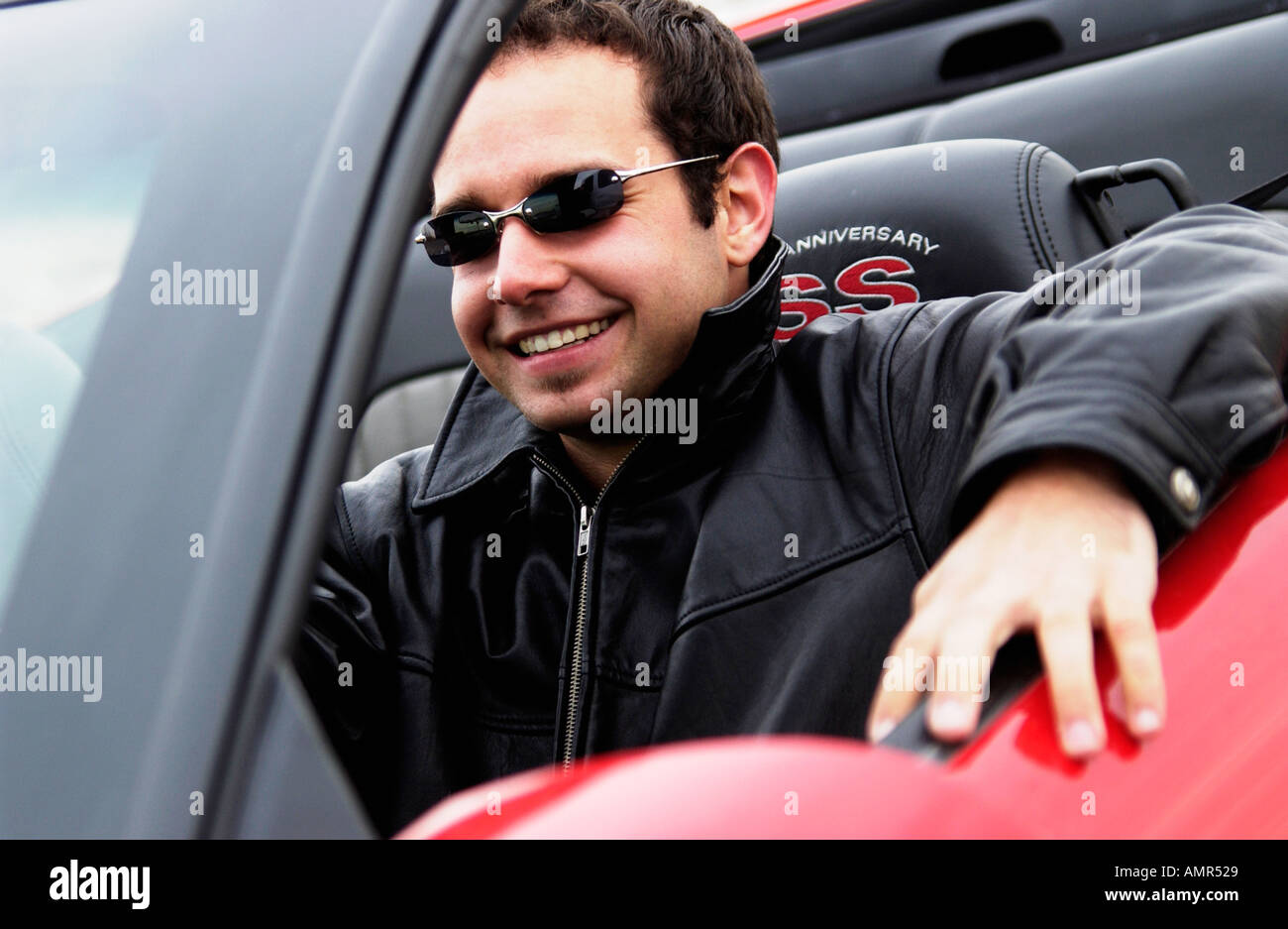 Man driving convertible Stock Photo - Alamy