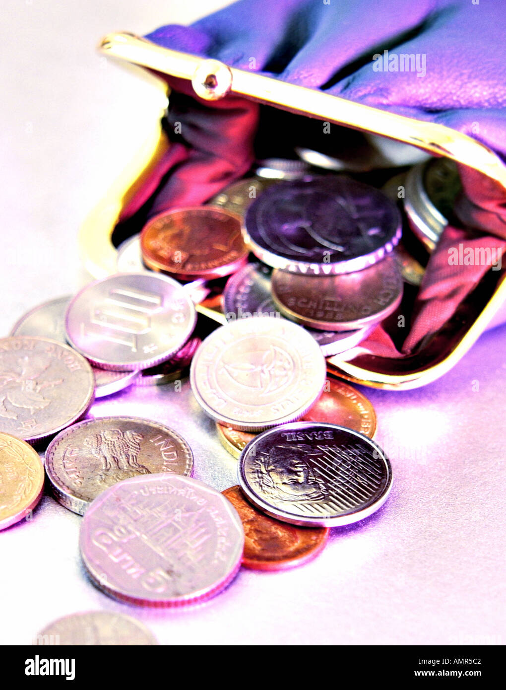 Purse open with coins falling out Stock Photo - Alamy