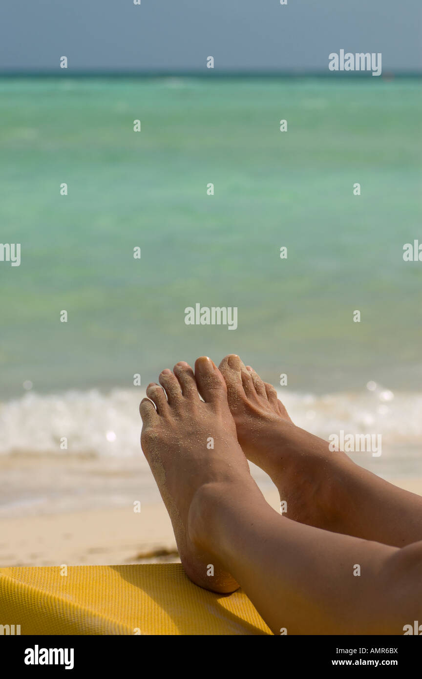 Feet on a beach chair Stock Photo - Alamy