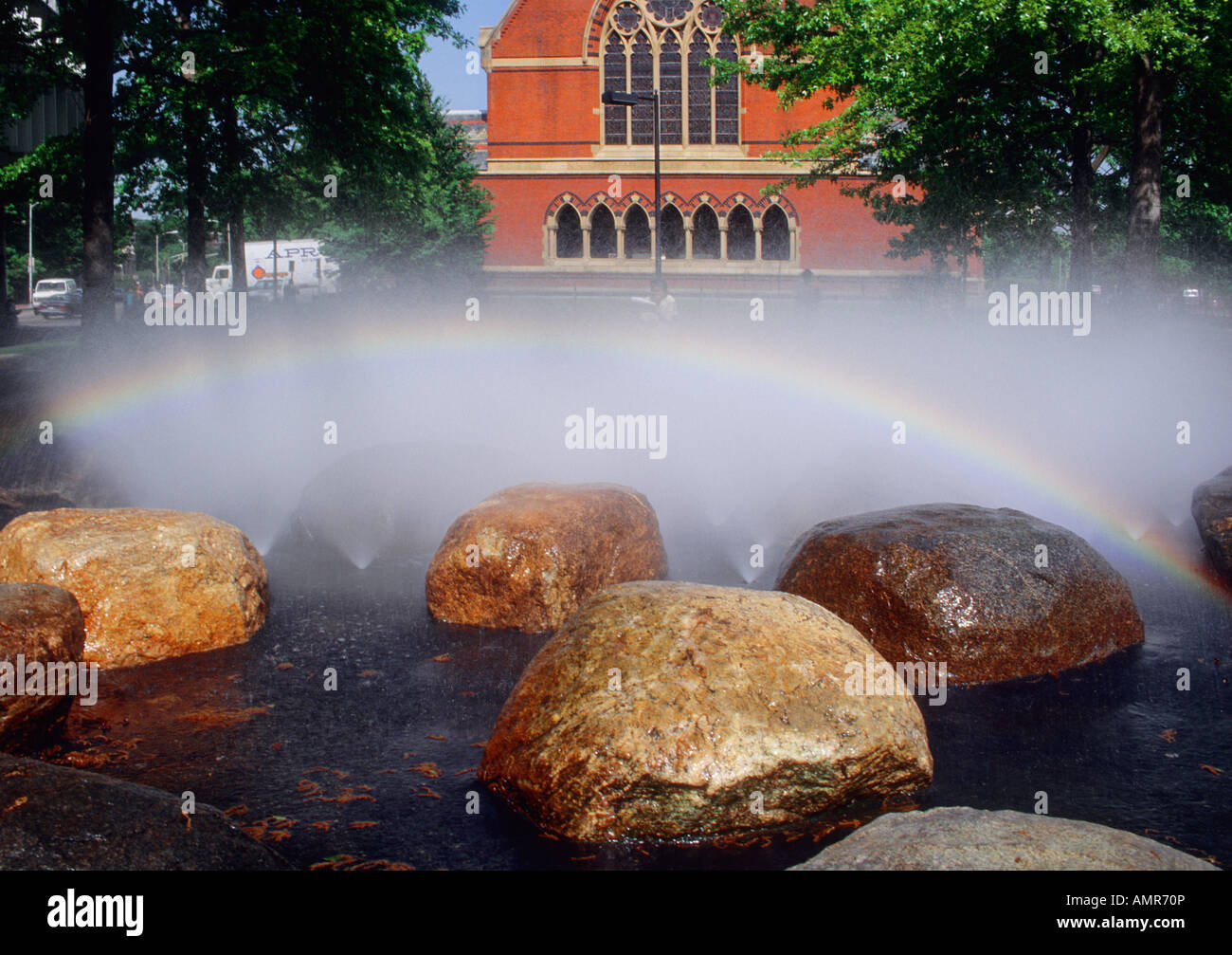Harvard University Memorial Hall exterior. Rainbow over stone boulders ...