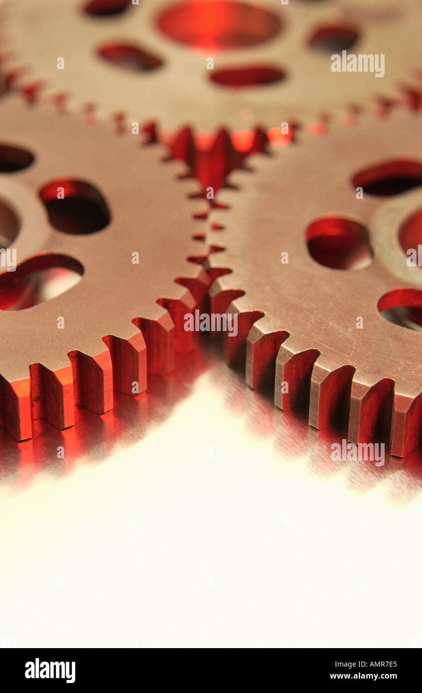 Metal cogs interlinked Stock Photo - Alamy