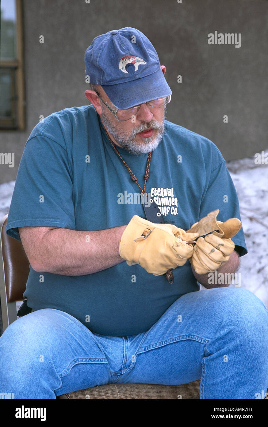 A flintknapping student is working on an arrowhead using the pressure ...