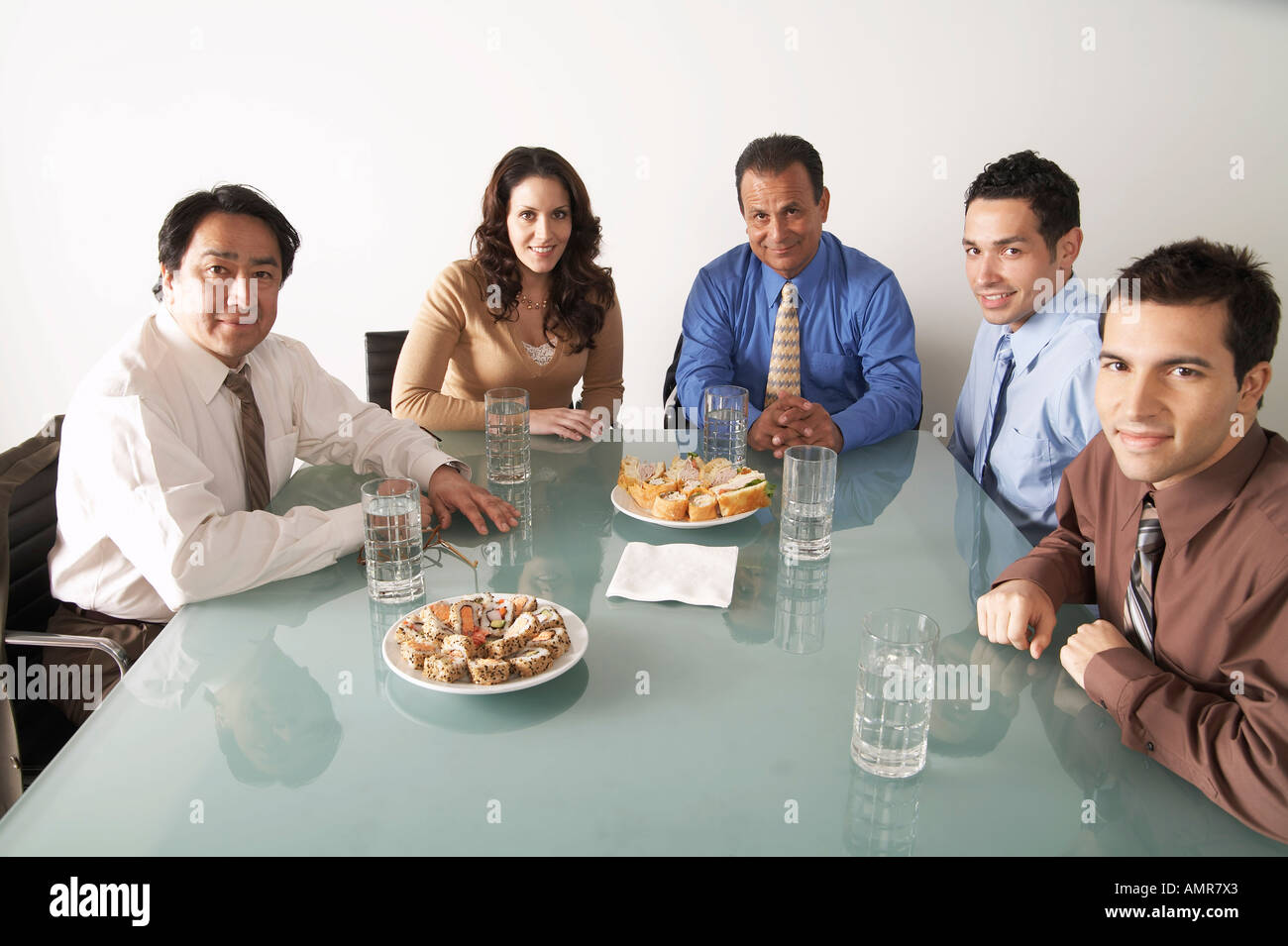 Five businesspeople boardroom table smiling hi-res stock photography ...