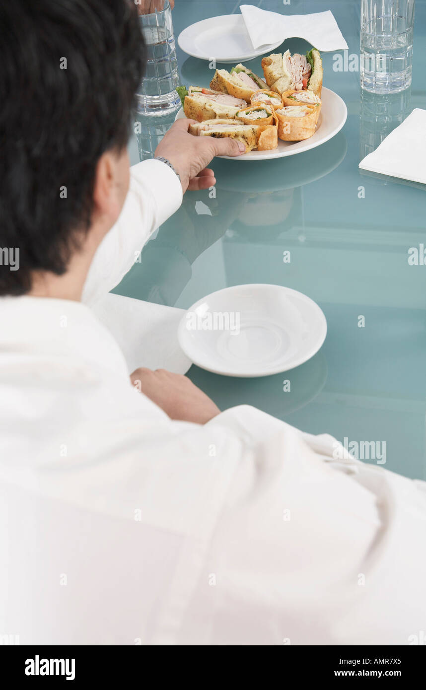 Man reaching over table hi-res stock photography and images - Alamy