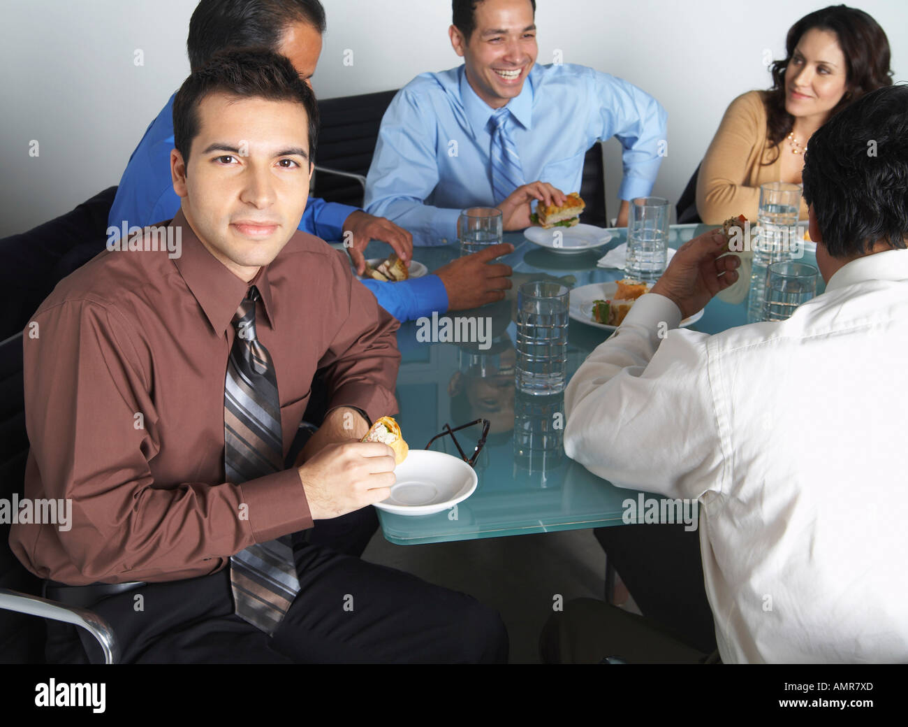 Business People with Snacks in Boardroom Stock Photo - Alamy