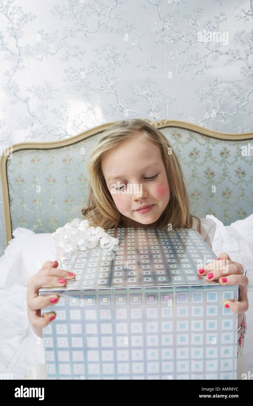 Girl Looking at Present Stock Photo - Alamy