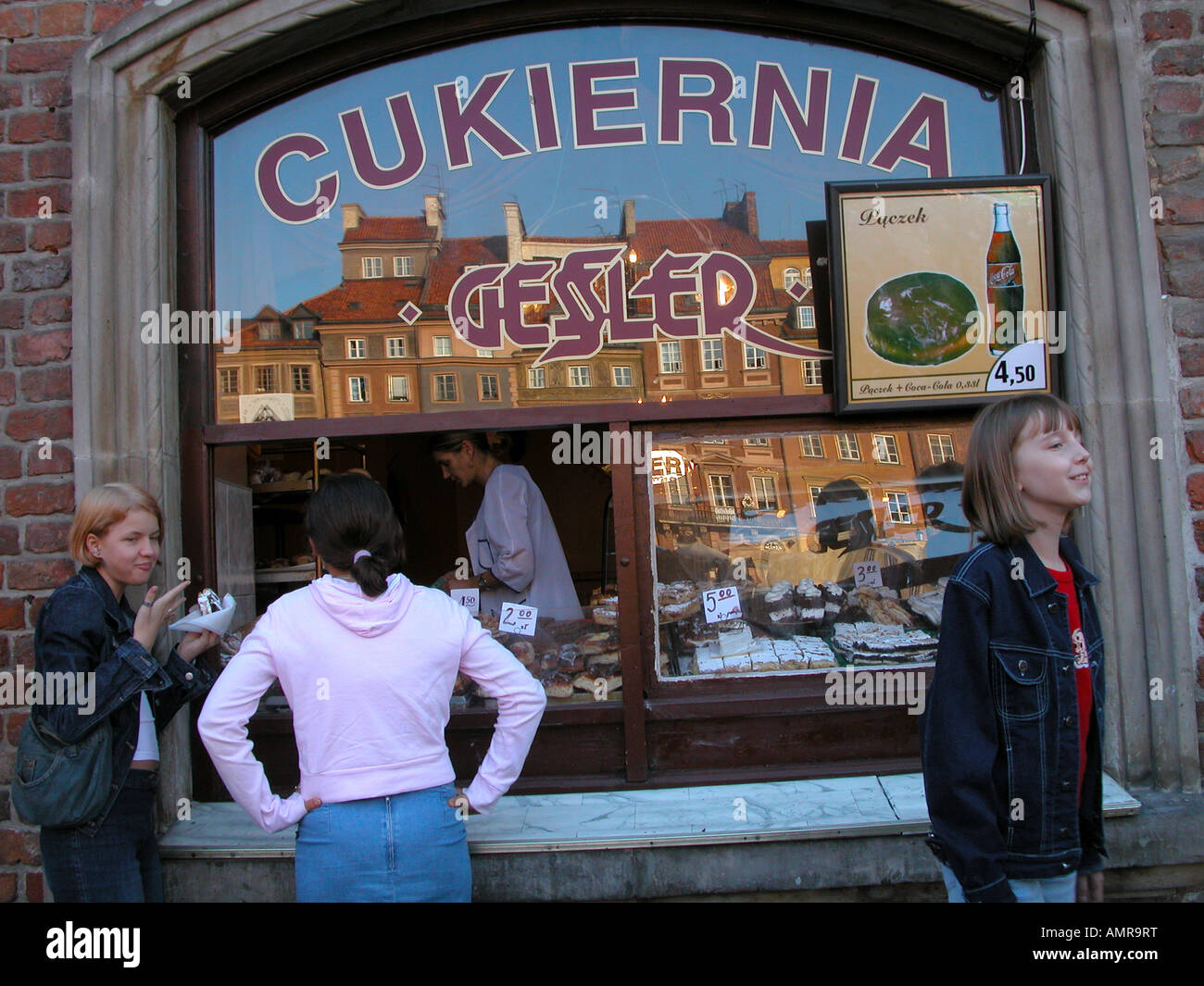three girls buying cakes from a cake shop in old town of warsaw Stock ...