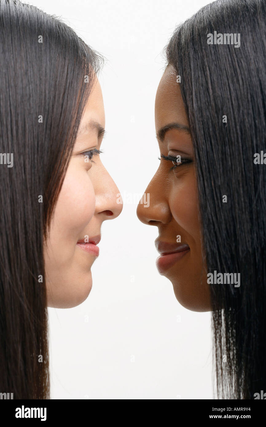 Two women facing each other close up hi-res stock photography and ...