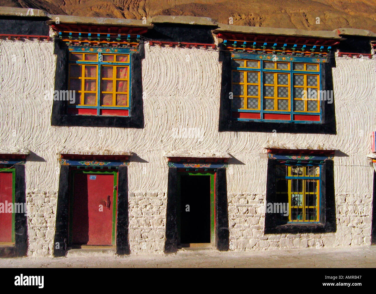 Traditional Tibetan houses with white walls black window surrounds and ...
