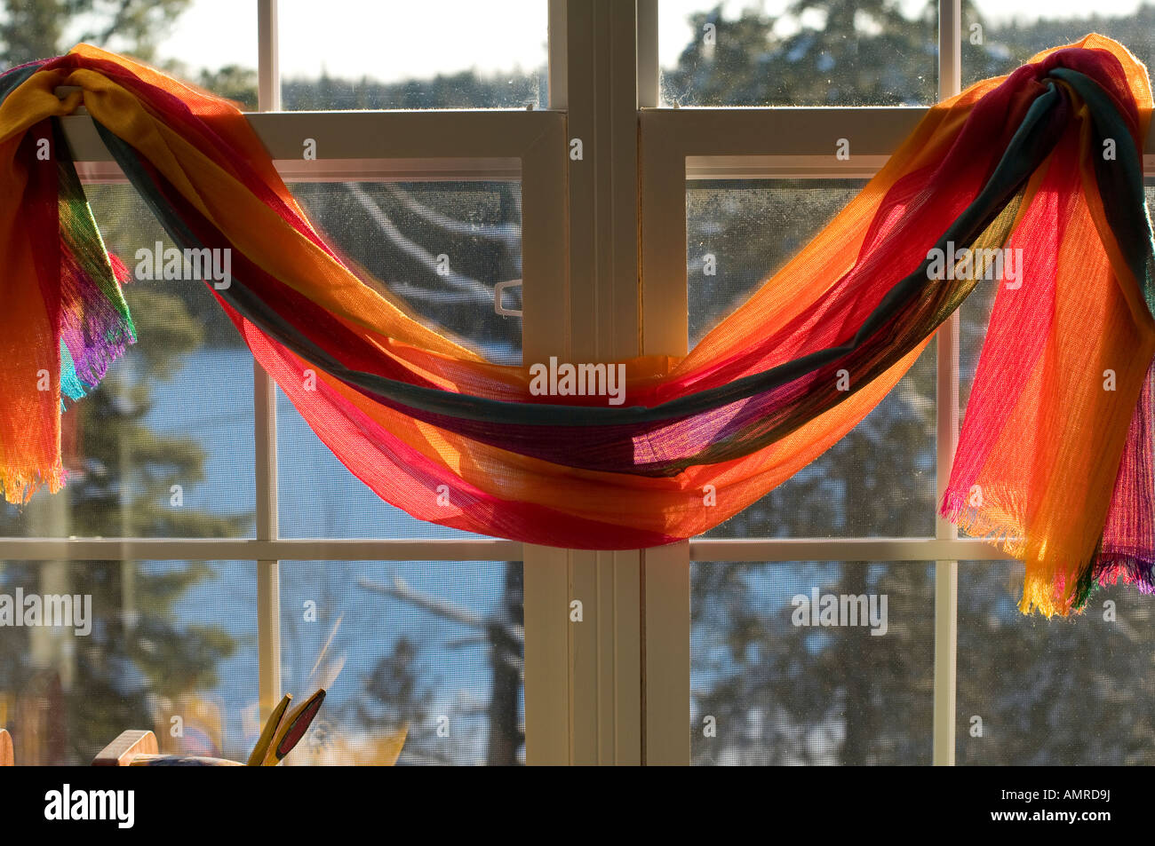 Multi coloured cloth draped on window Stock Photo - Alamy