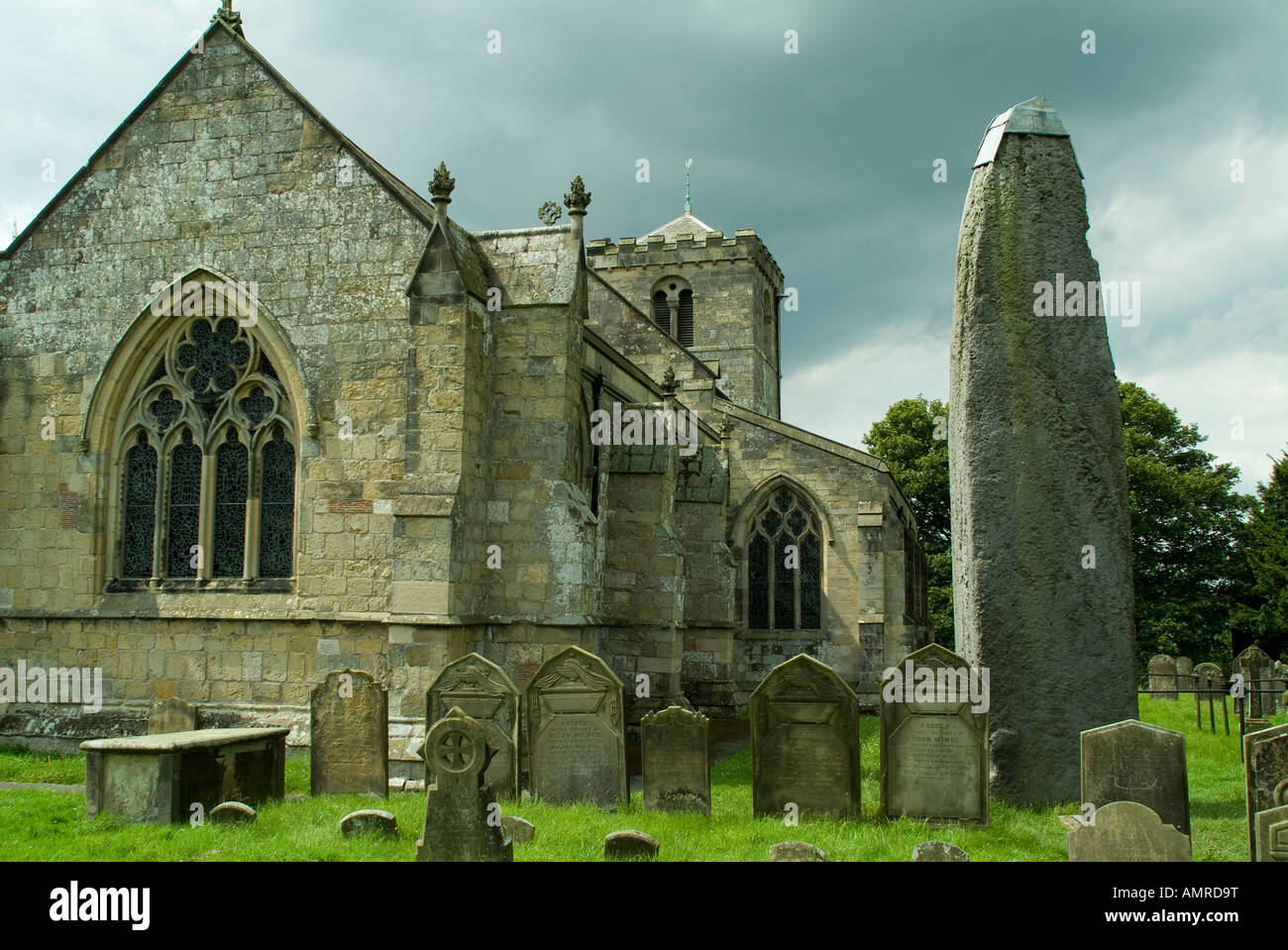 Rudston standing stone and All Saints Church Stock Photo - Alamy