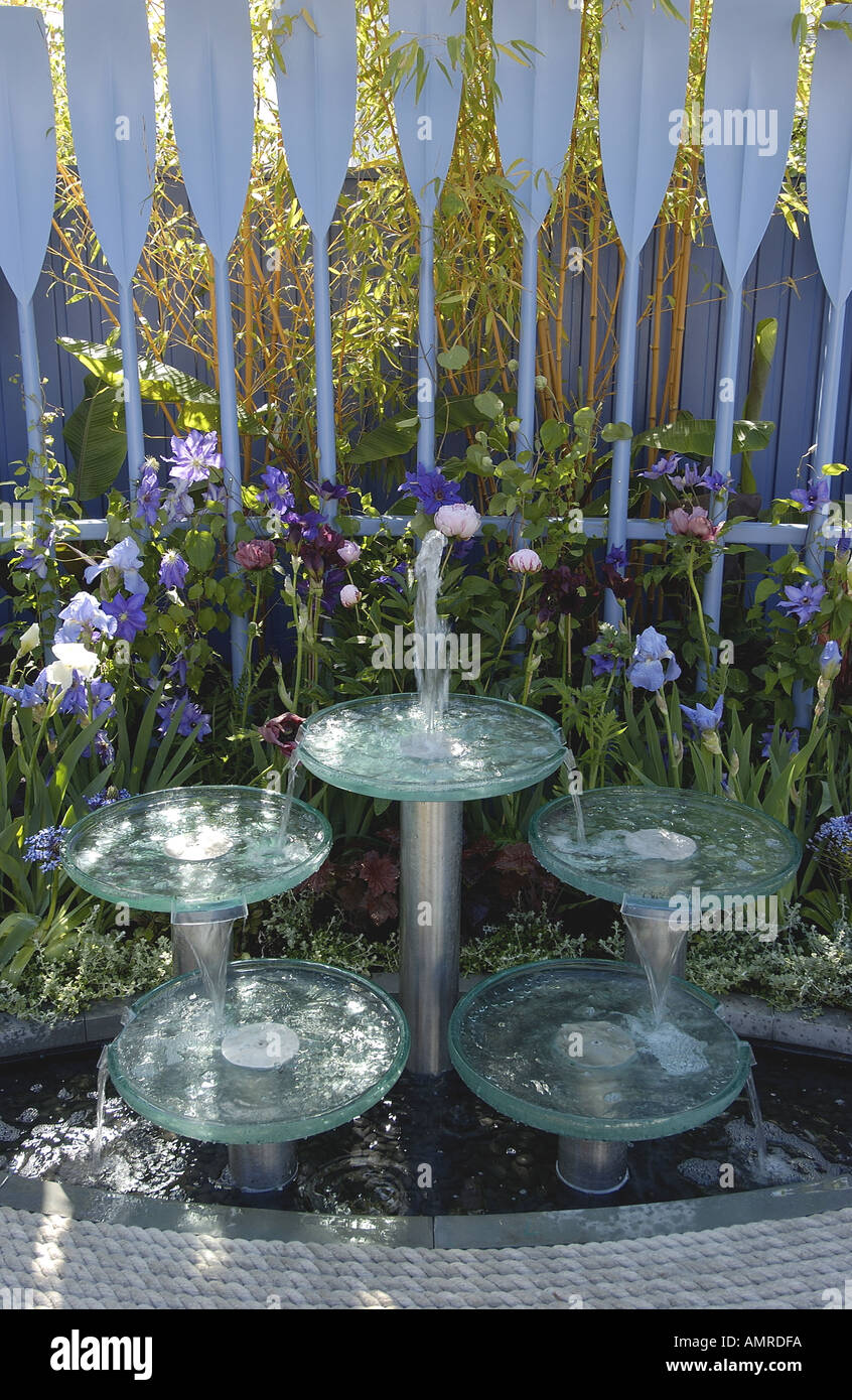 Five raised circular fountains cascading into a pool Stock Photo - Alamy