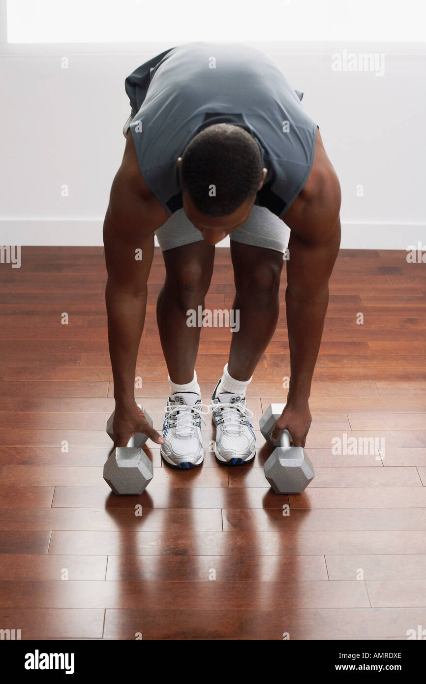 Fit muscular male bending down hi-res stock photography and images - Alamy