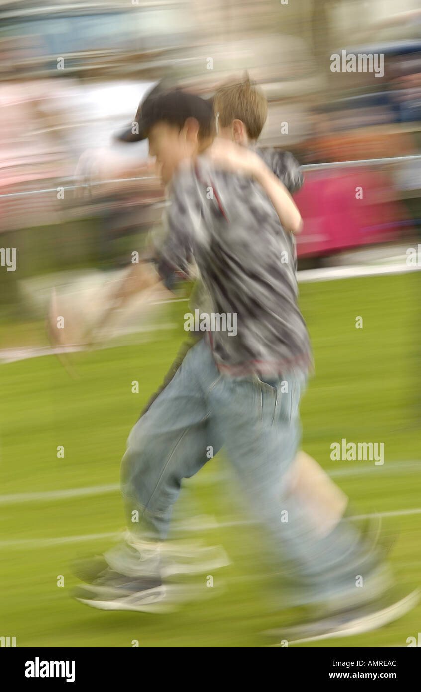 Boys running in a three legged race Stock Photo - Alamy