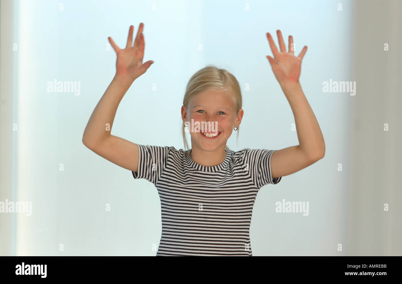 Girl (10-12) arms up Stock Photo - Alamy