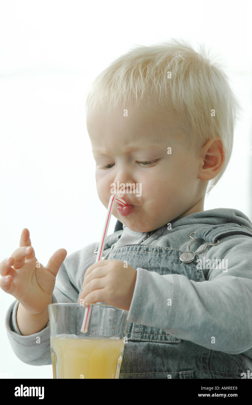 Boy (2-3) drinking with straw Stock Photo - Alamy