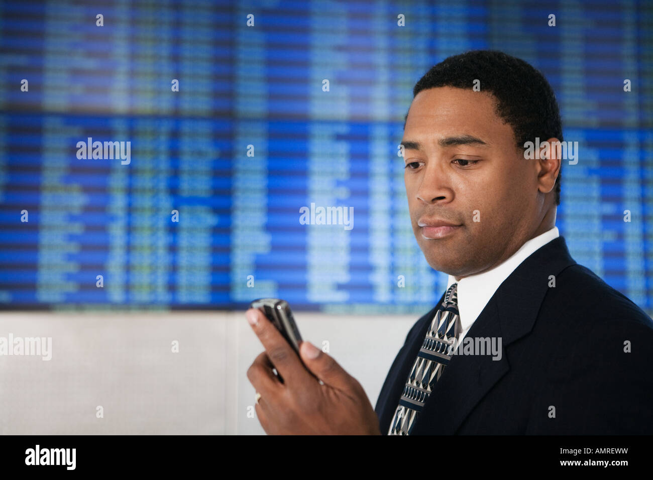 African businessman looking at cell phone Stock Photo - Alamy