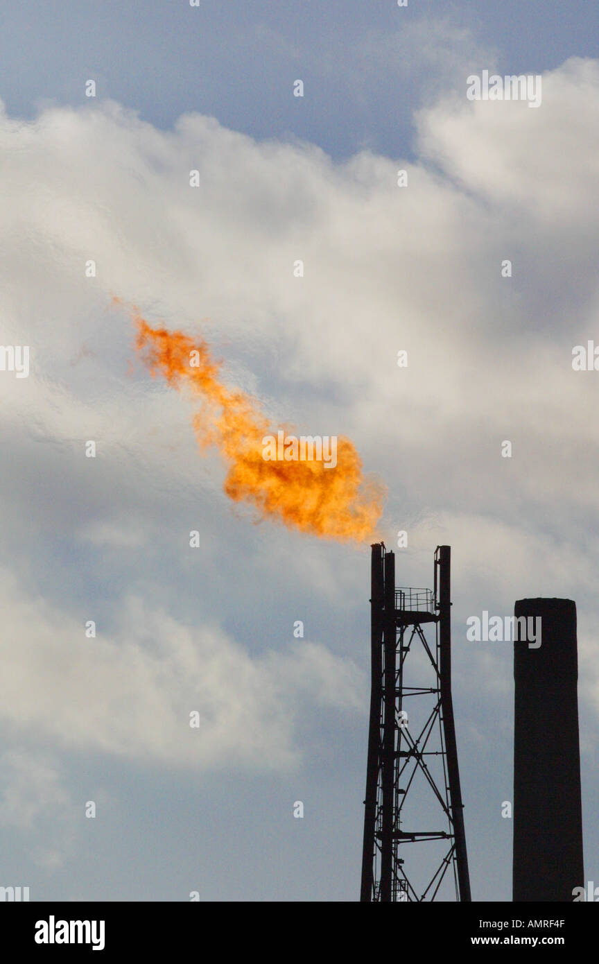 Burning off waste gases through a gas flare stack chimney Stock Photo ...
