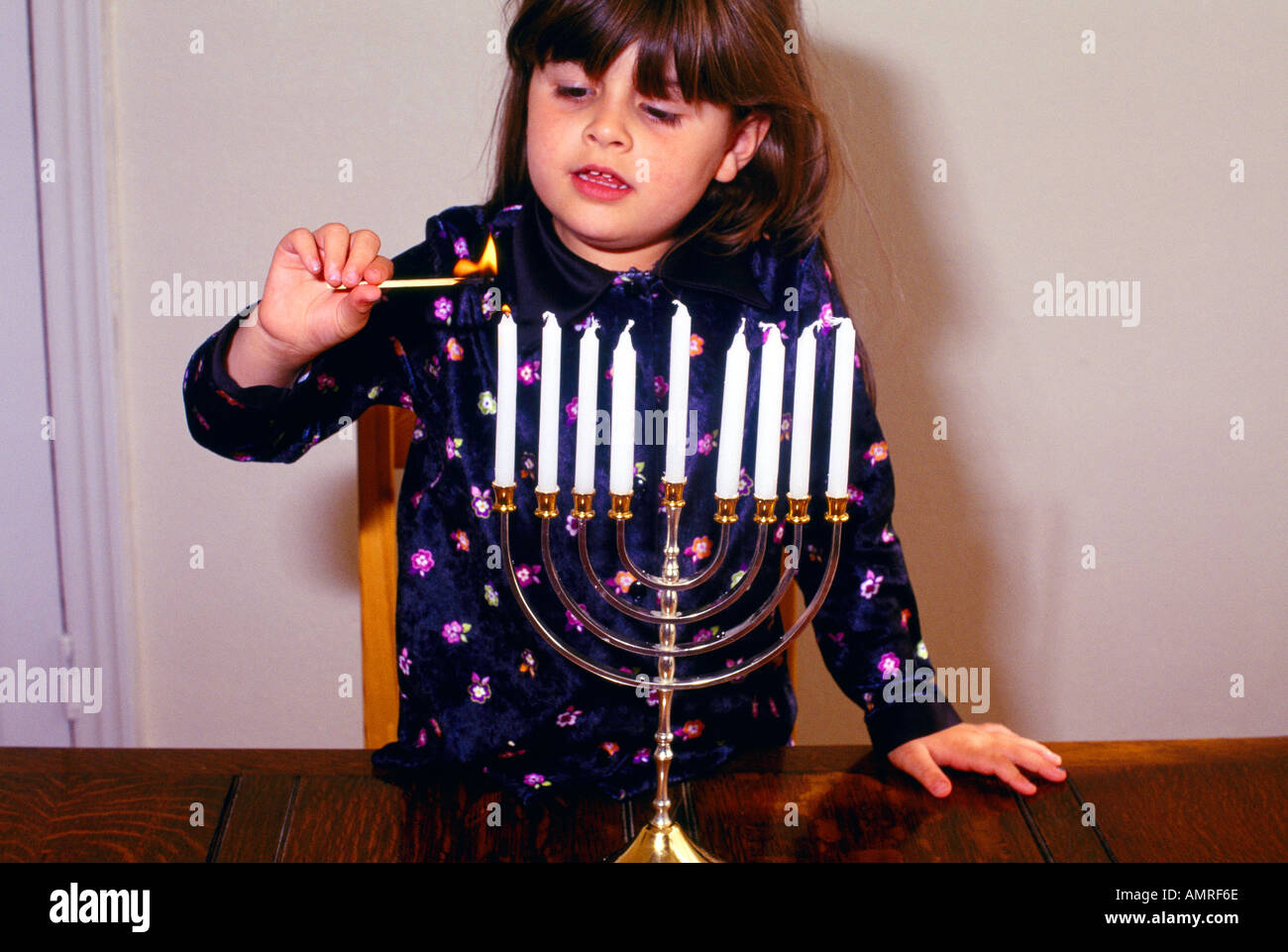 Menorah Child Lighting Candles Stock Photo - Alamy