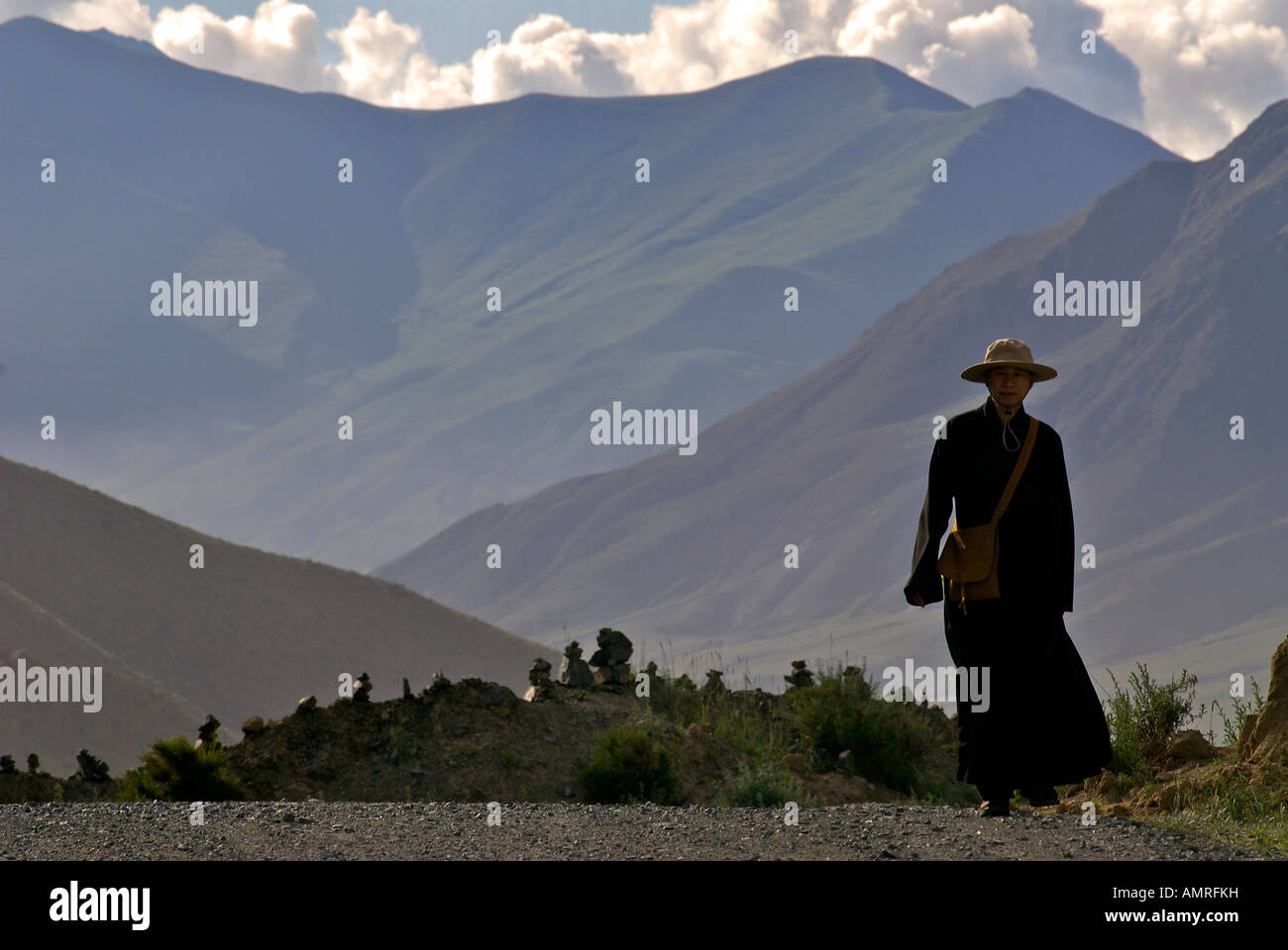 Buddhist pilgrim walking the road to a mountain pass Tibet Stock Photo ...