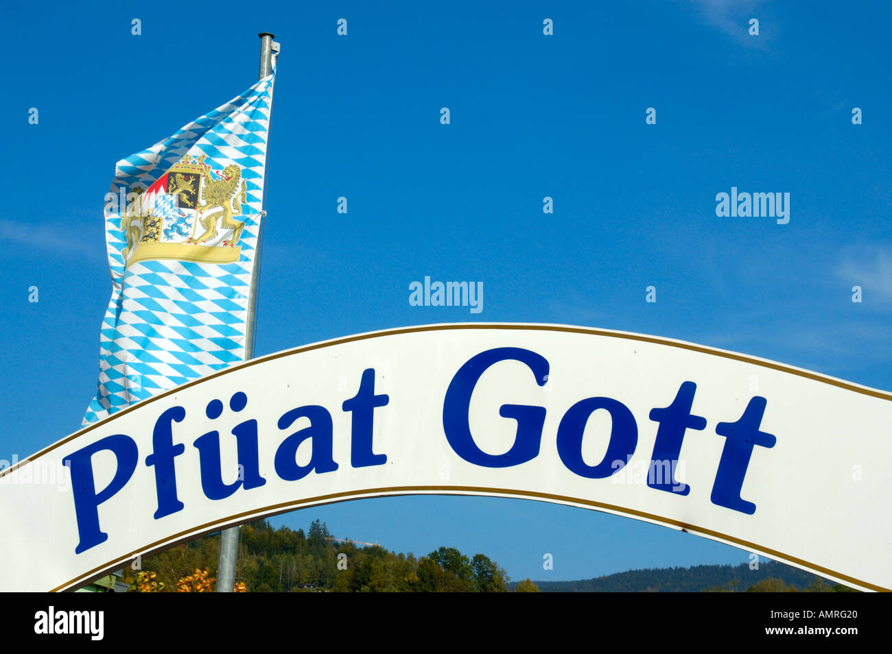 Sign Pfüat Gott in Bavarian language with flag in a beer garden in ...
