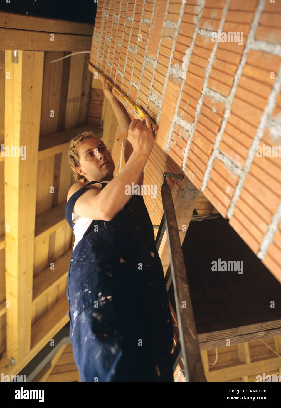 Carpenter measuring wall Stock Photo - Alamy