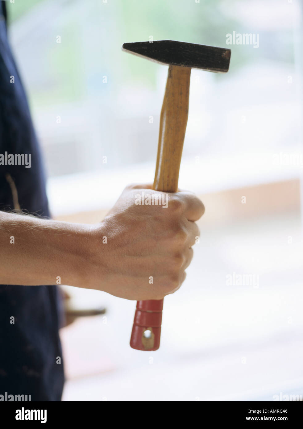 Man holding hammer, midsection Stock Photo - Alamy