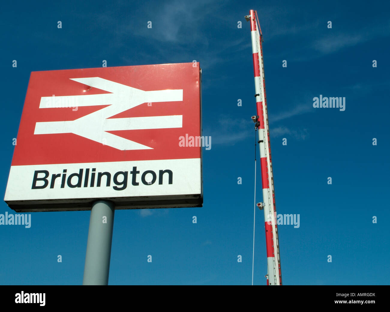Bridlington Station sign and level crossing barrier pole Stock Photo ...