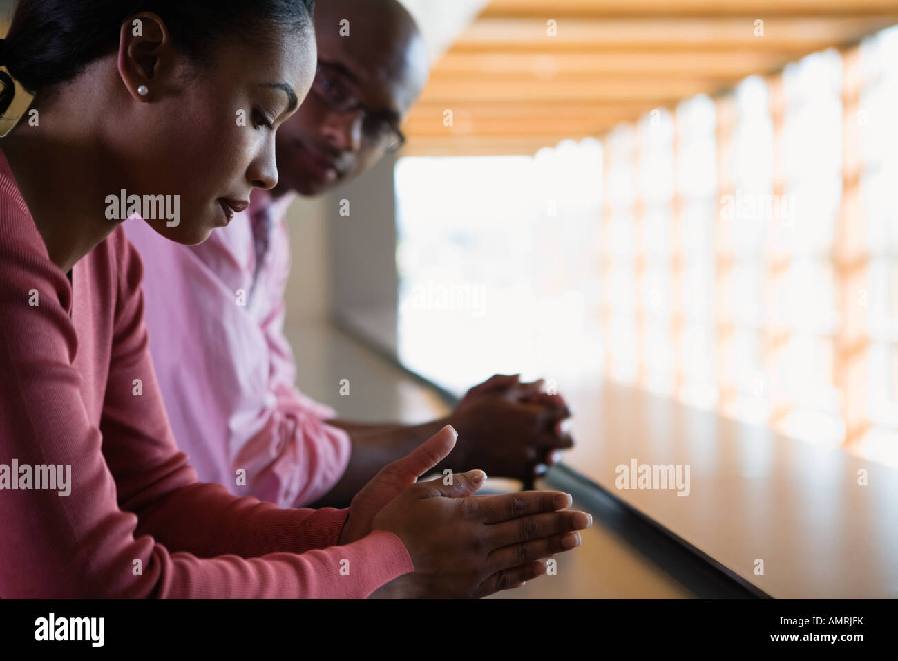 African couple leaning on railing Stock Photo - Alamy