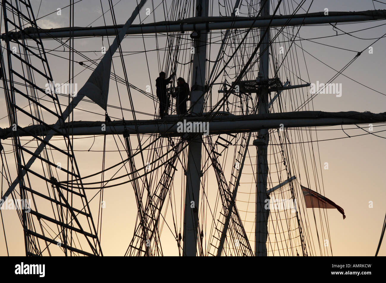 crew members of tall ship climb the rigging at sunset Stock Photo - Alamy