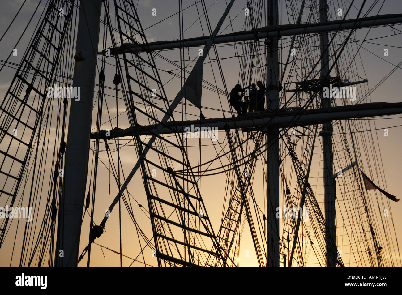 crew members of tall ship climb the rigging at sunset Stock Photo - Alamy