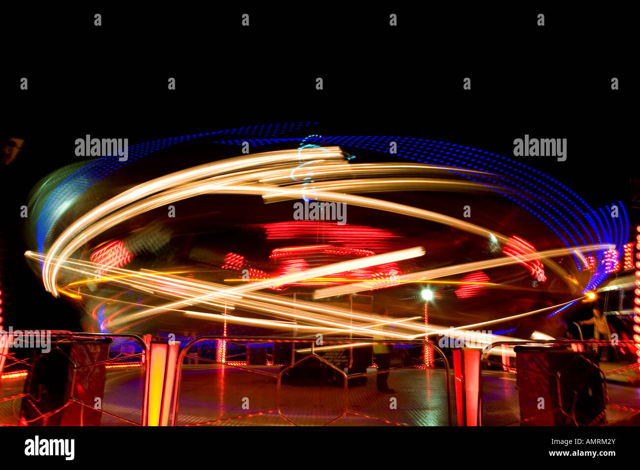 Light trails on fairground ride at night Stock Photo - Alamy