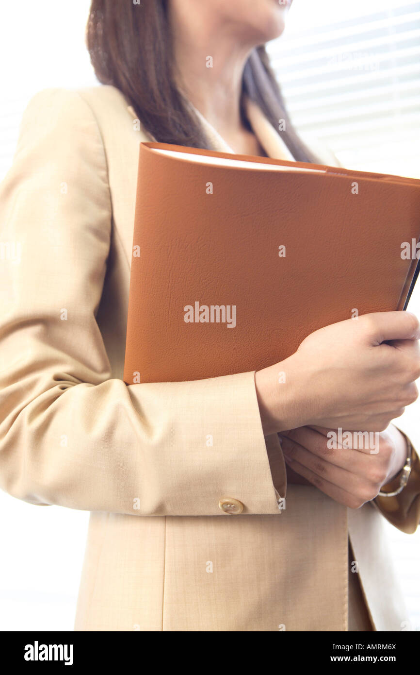 Secretary holding a file Stock Photo - Alamy