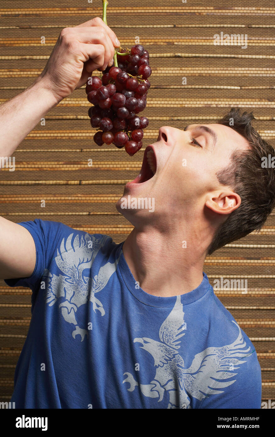 Funny man eating grape hi-res stock photography and images - Alamy