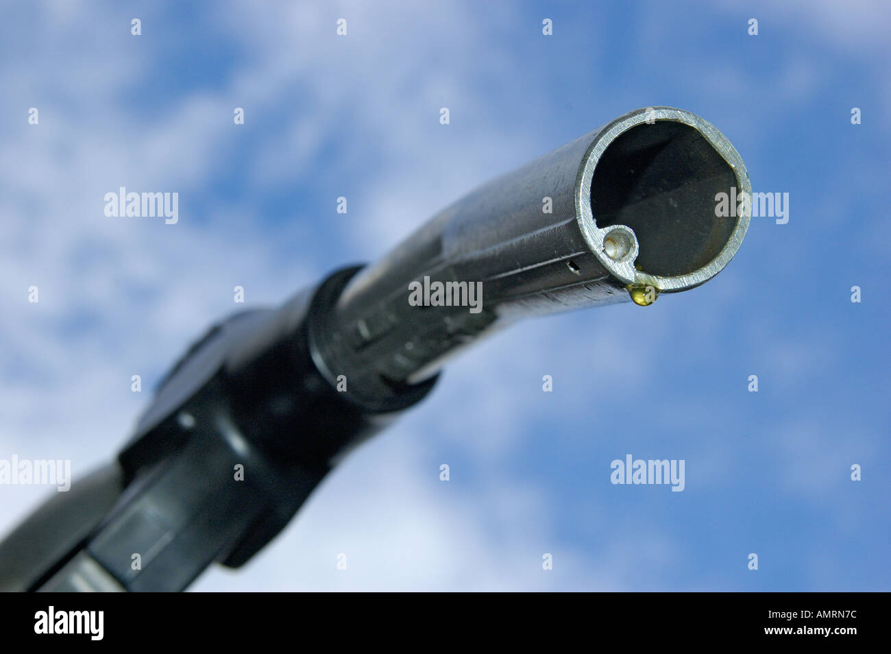 Dripping fuel pump in front of a blue sky Stock Photo - Alamy