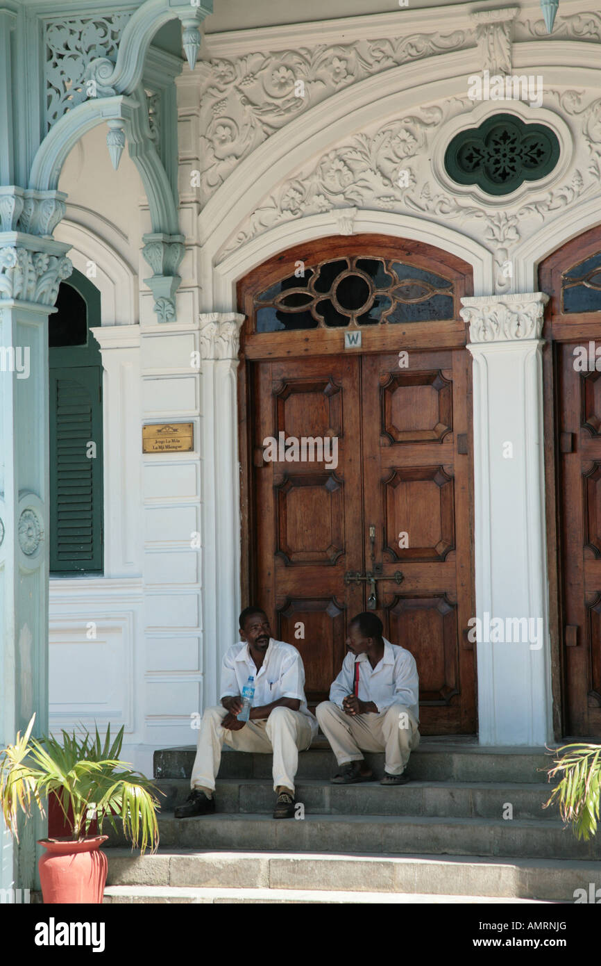 Two local men sitting outside one of the many 'colonial' style ...