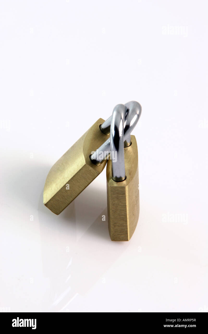 safety and security concepts two metalic padlocks locked each other ...