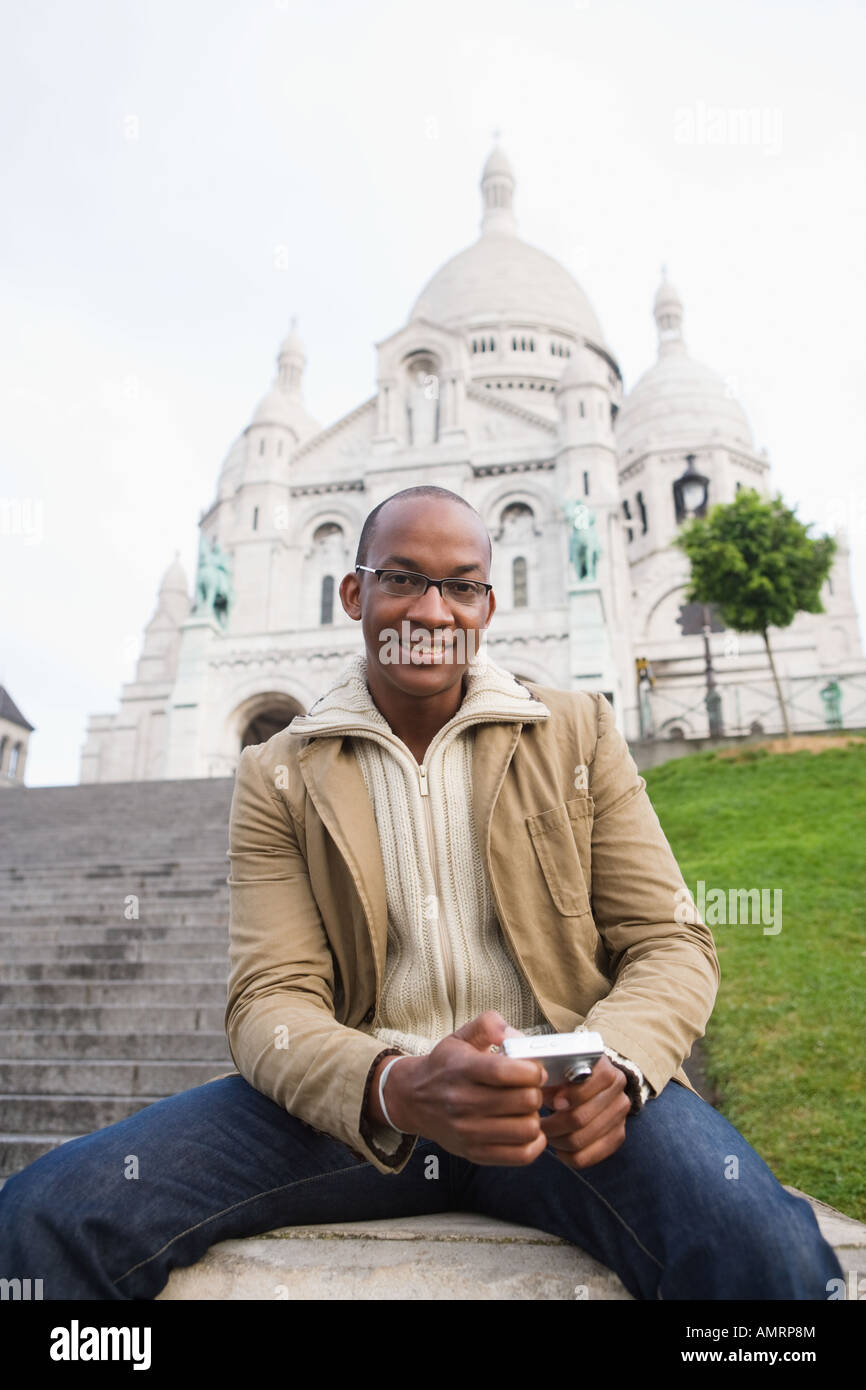 African man holding camera Stock Photo - Alamy