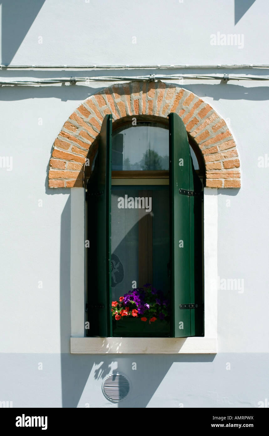 Flower box in a traditional arched window, Burano, near Venice, Italy ...