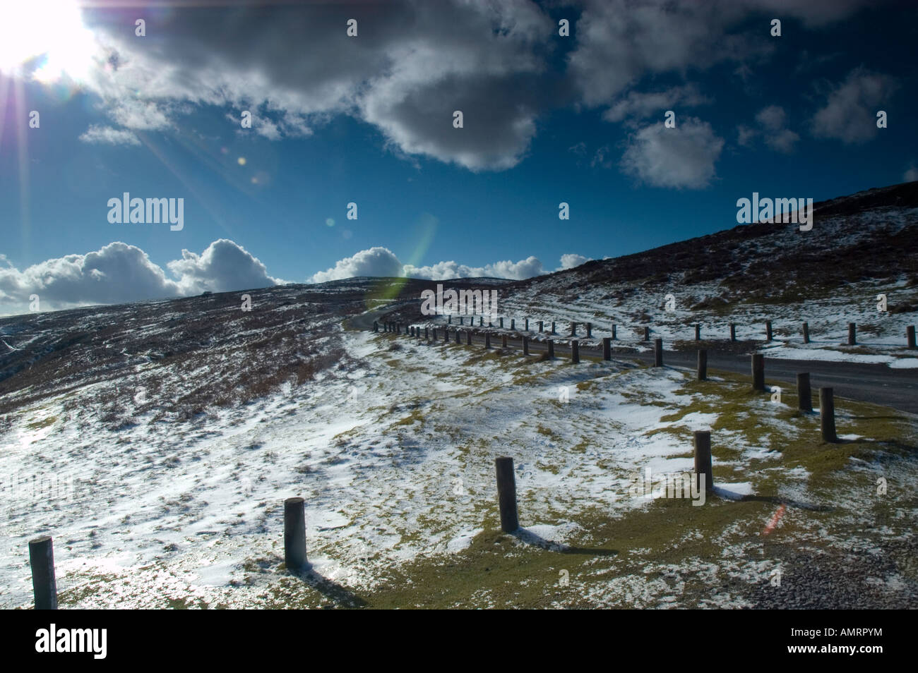 Winter scene of snowy fields, hills and pathway with a blue sky with ...