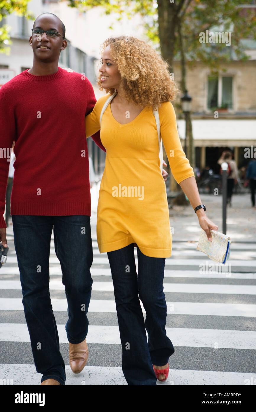 African couple walking across street Stock Photo - Alamy