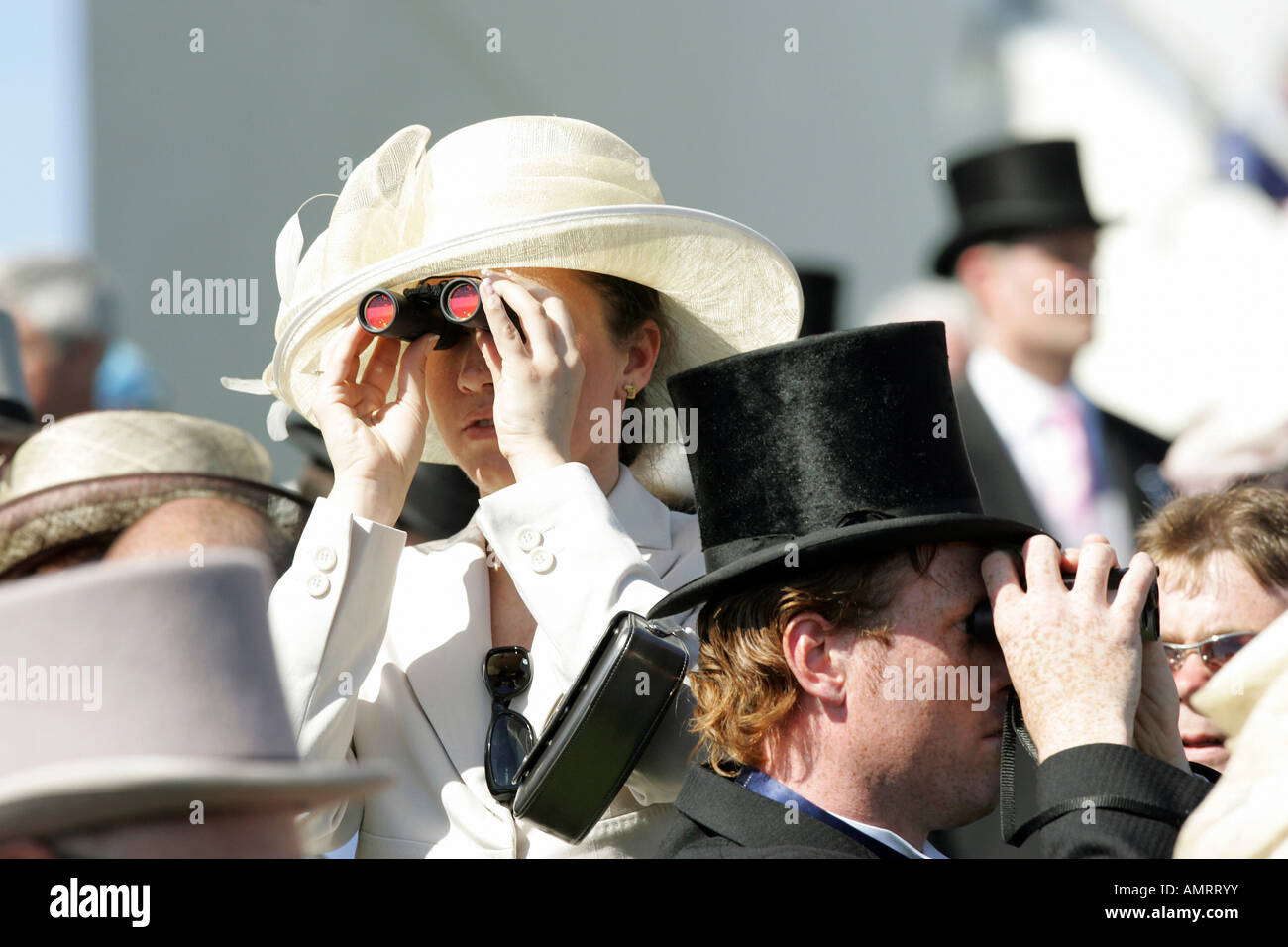 People looking through binoculars at horse races in Epsom, Great ...
