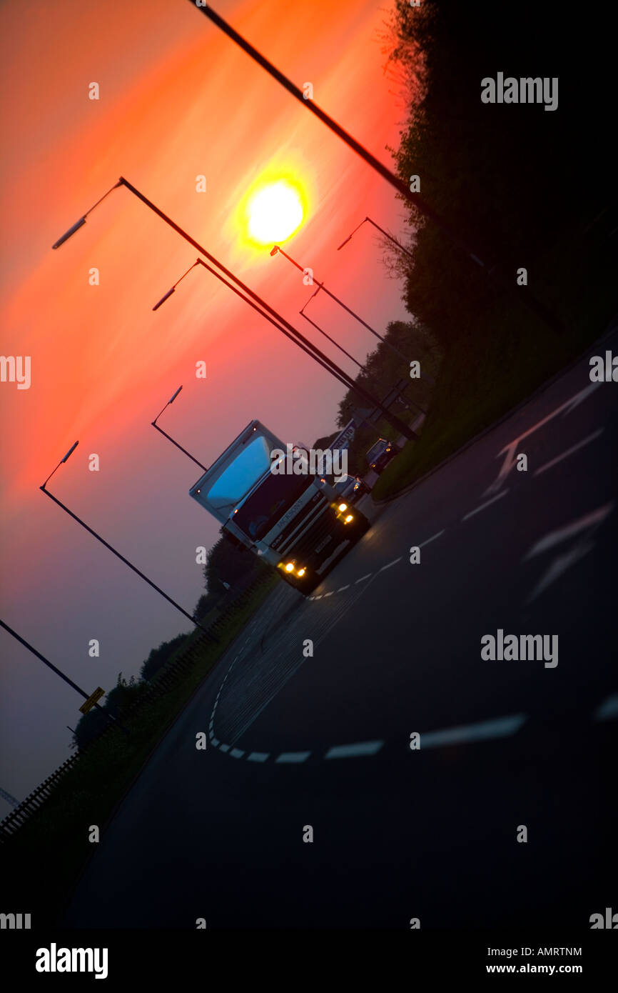 Sun set lorry on road Stock Photo - Alamy