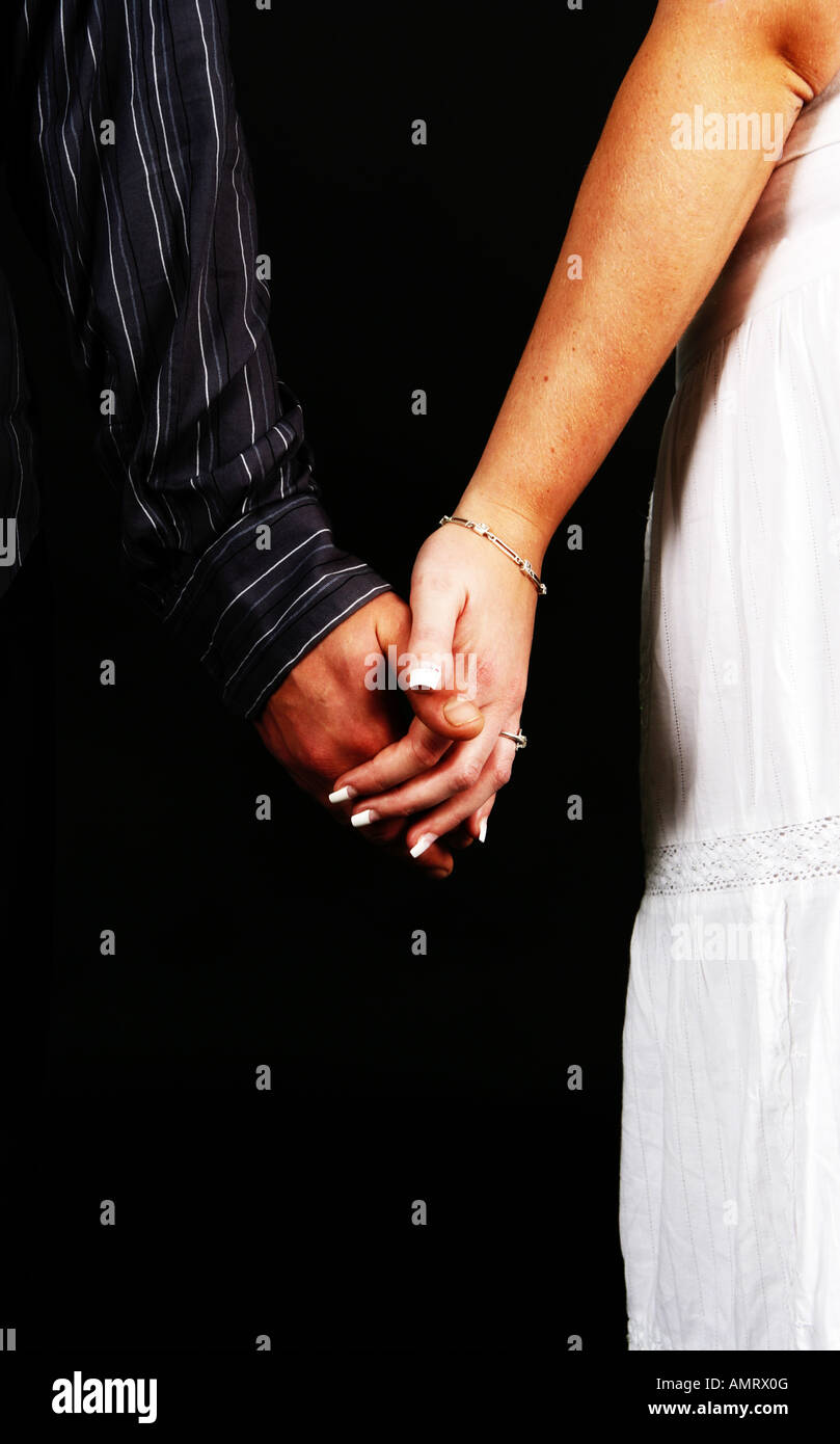 Man and woman holding hands Stock Photo - Alamy